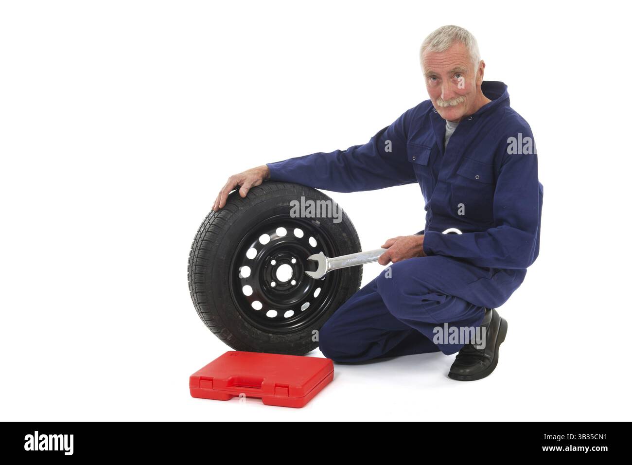 Mechanic repair a wheel with wrench isolated over white background ...