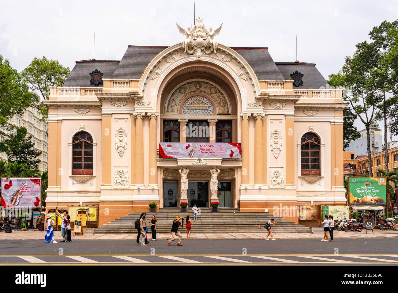 Ho Chi Minh City (Saigon), Vietnam-February 15, 2025: Tourists walk by the famous Saigon Opera ...