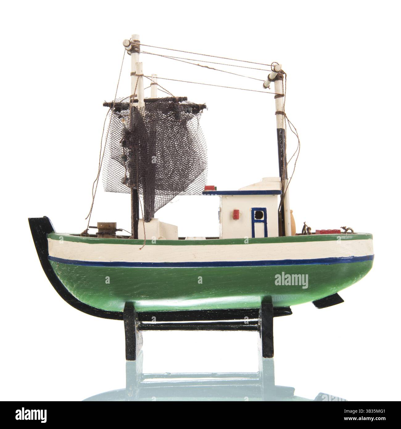 Miniature green fishing trawler isolated over white background Stock ...