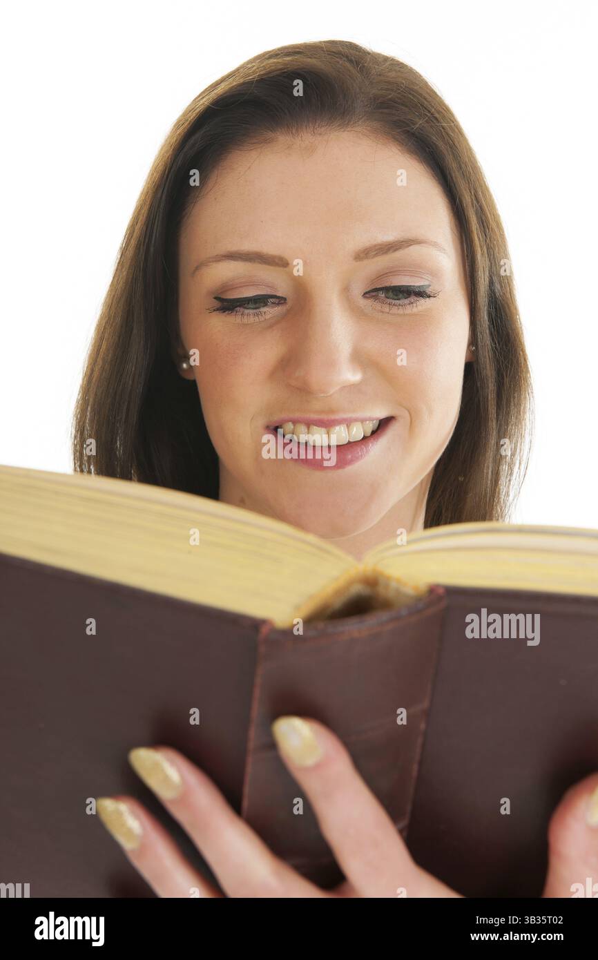 Attractive young girl reading thick old book Stock Photo - Alamy