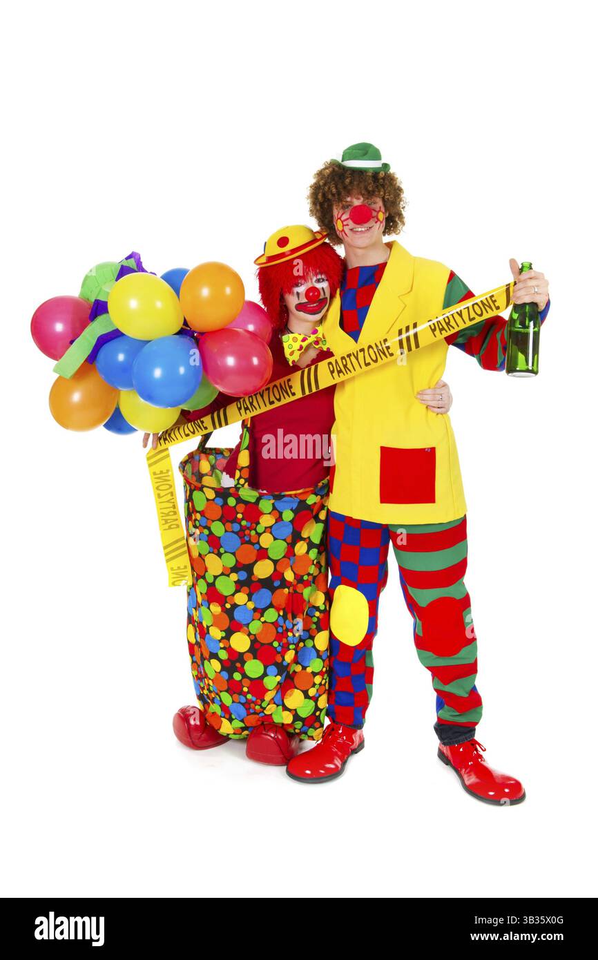 Couple funny full dressed clowns with bottle wine in party zone Stock ...