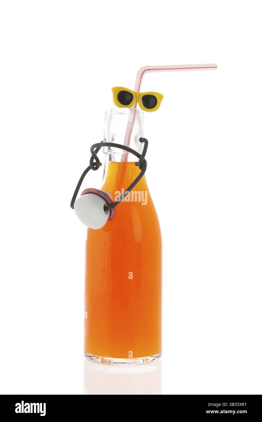Glass bracket bottle with orange soft drink and drinking strw isolated ...