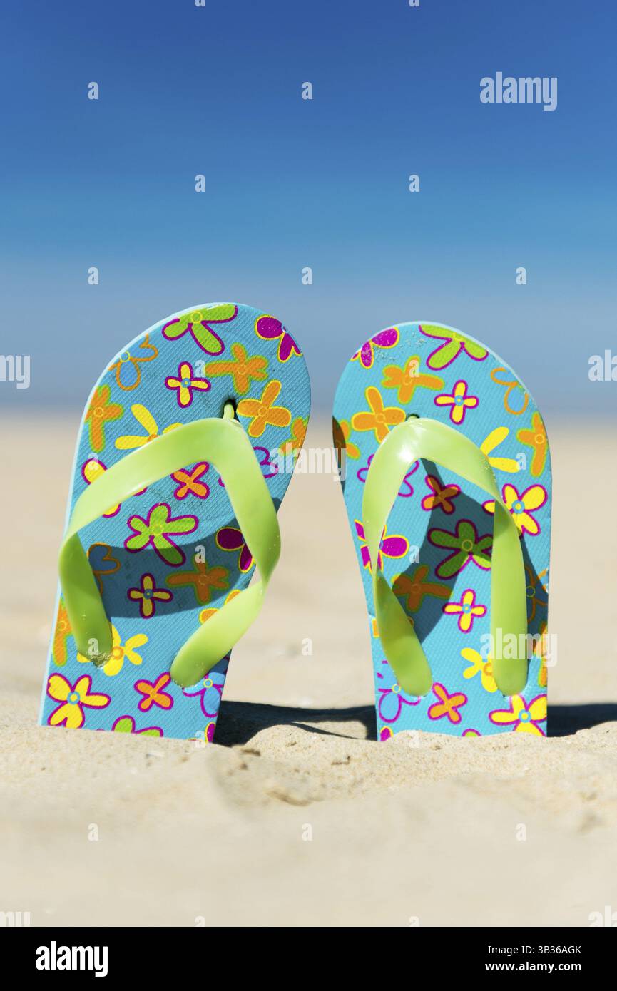 Pair colorful flip flops at the beach Stock Photo - Alamy