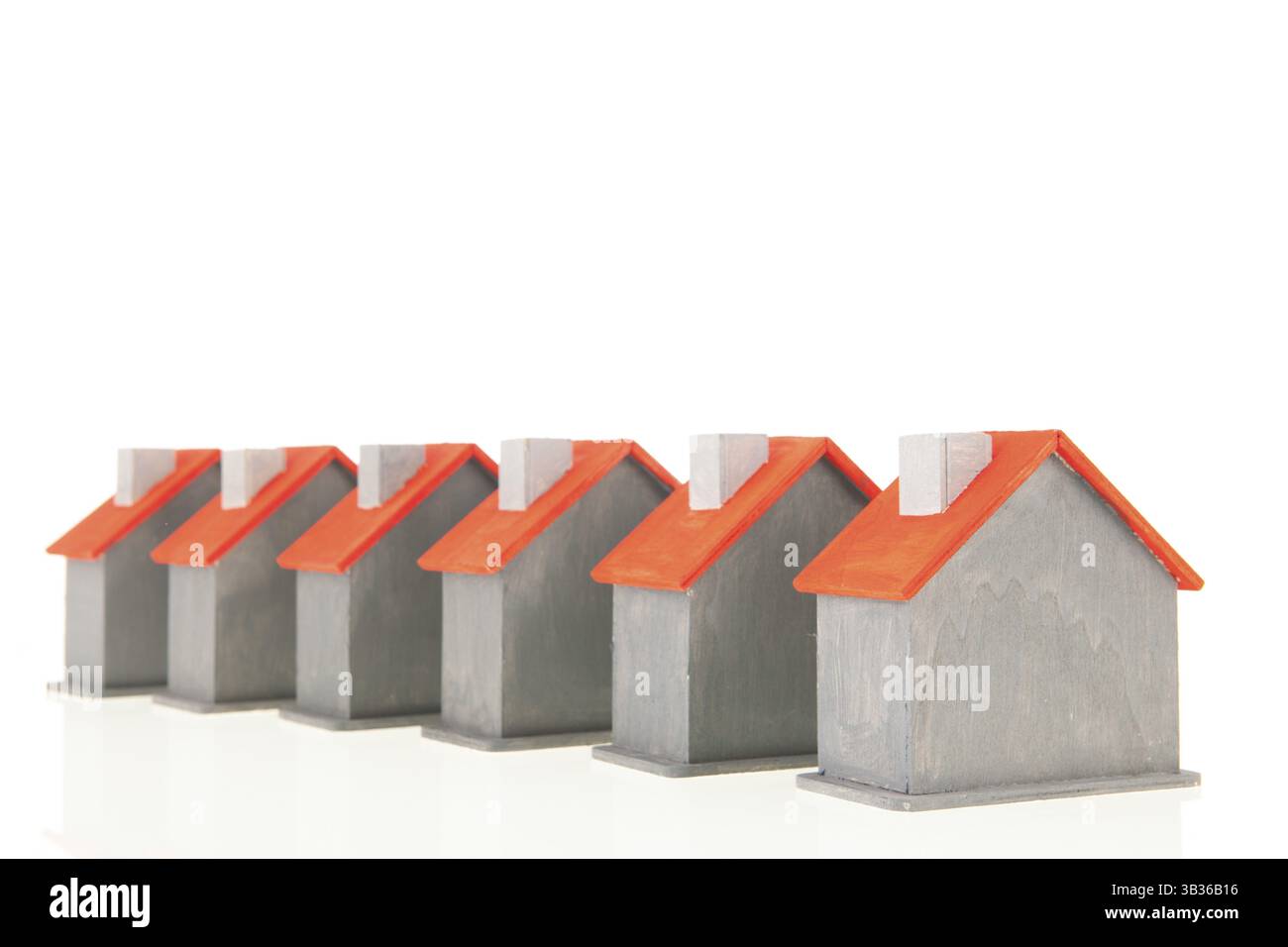 Row wooden houses same in gray and red isolated over white background ...