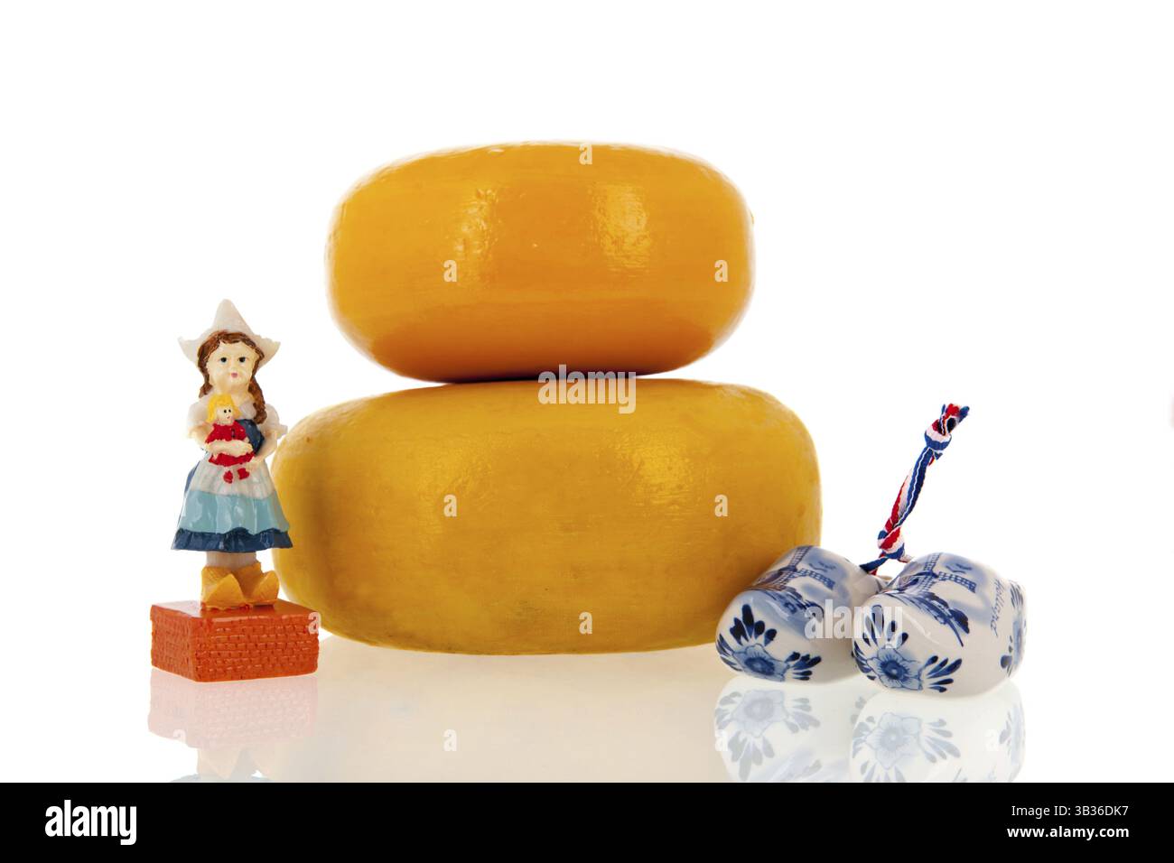 Dutch cheese with souvenirs and two stacked whole cheeses isolated over ...