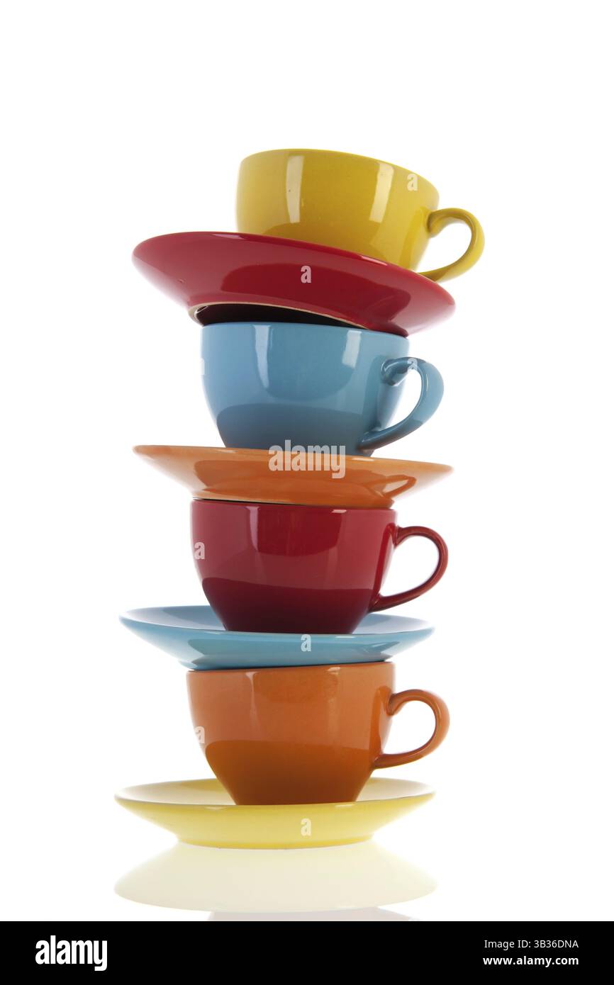 Stacked colorful cups and saucers isolated over white background Stock ...