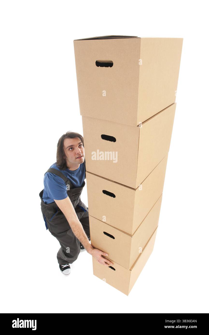 Mover with big stack of heavy boxes Stock Photo - Alamy