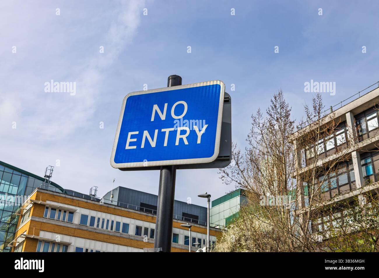 Road sign indicating no entry zone, placed on street with modern ...