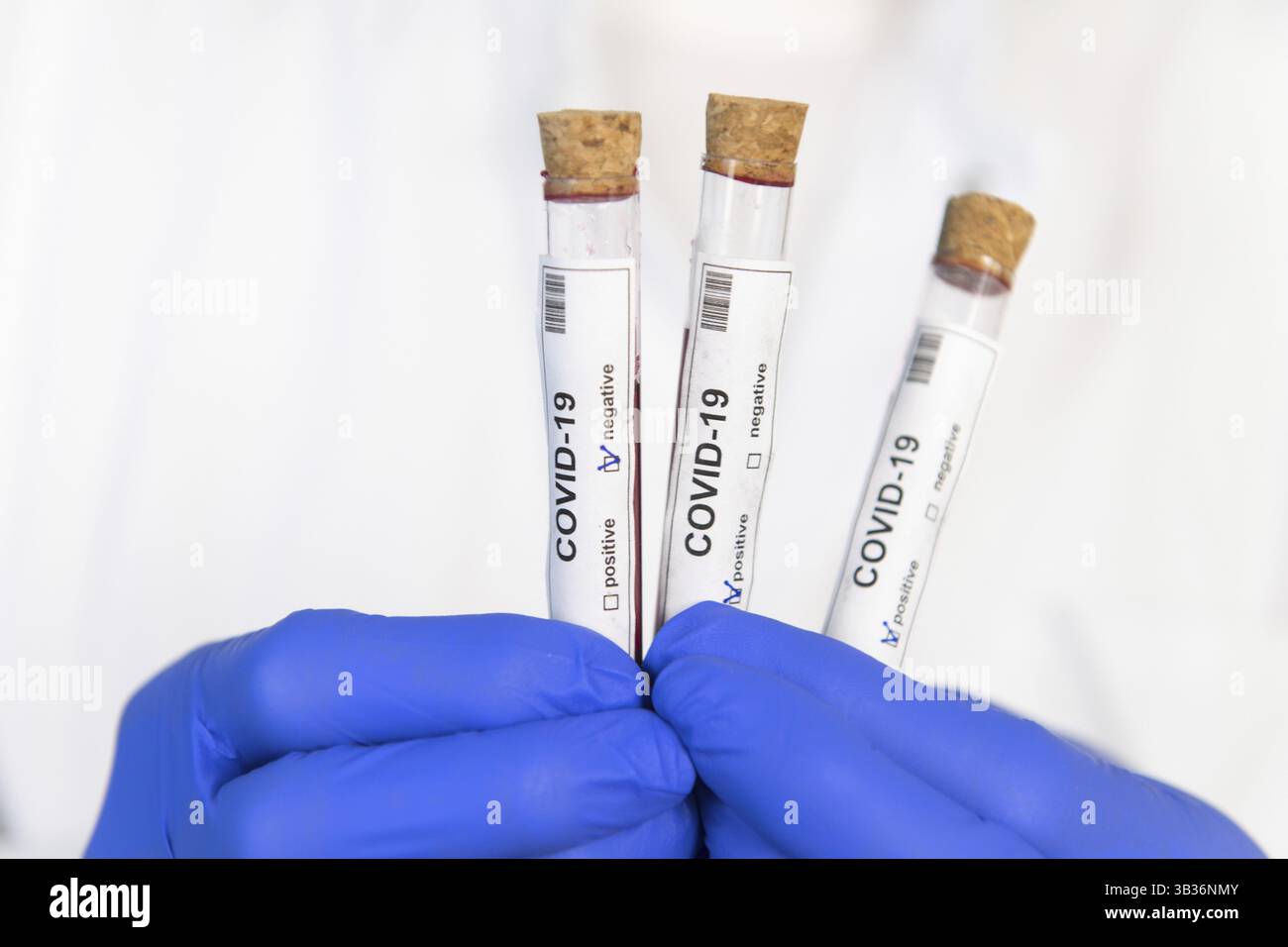 Doctor with positive and negative covid-19 test Stock Photo - Alamy