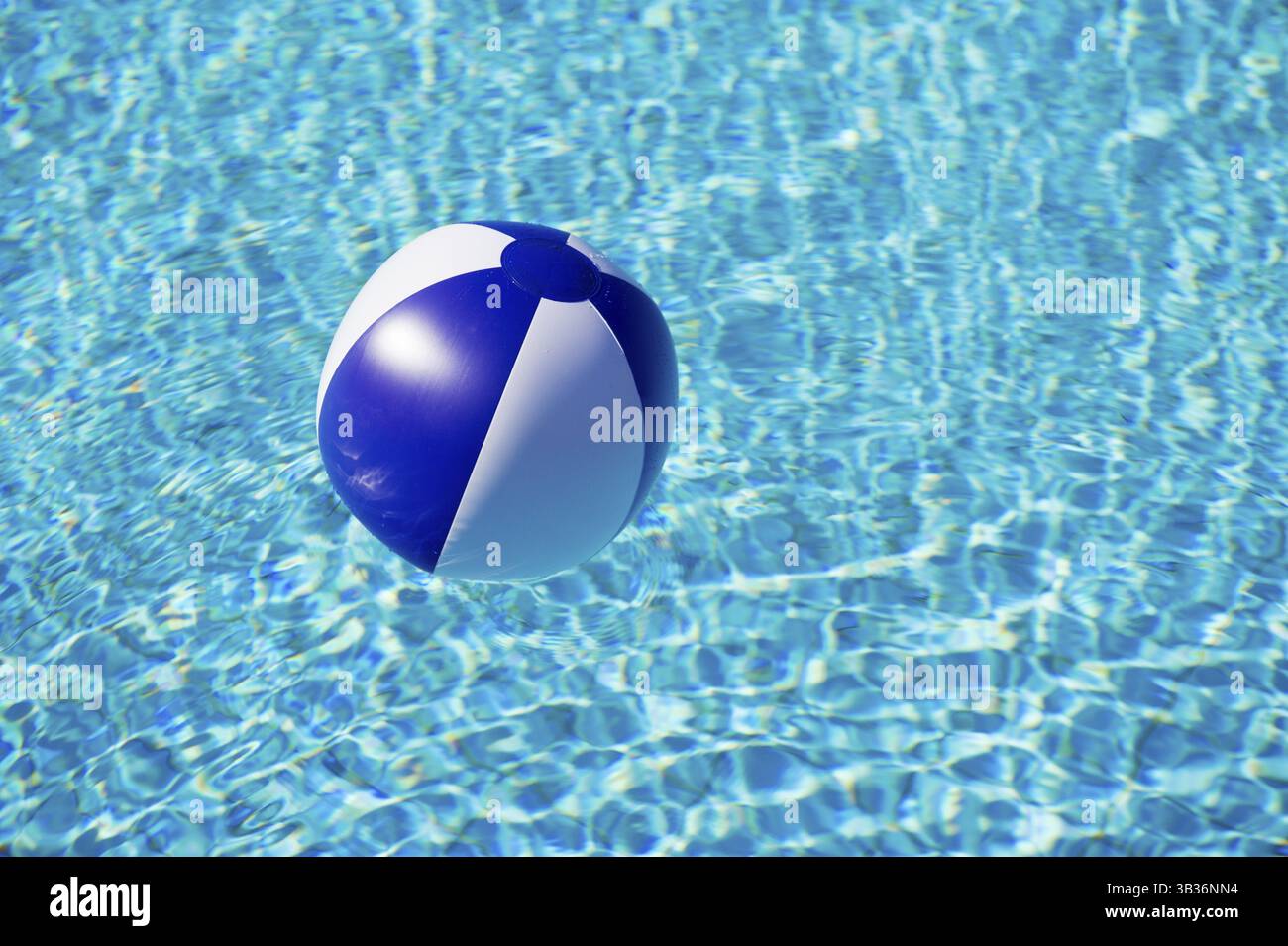 Floating blue and white beachball in swimming pool Stock Photo - Alamy
