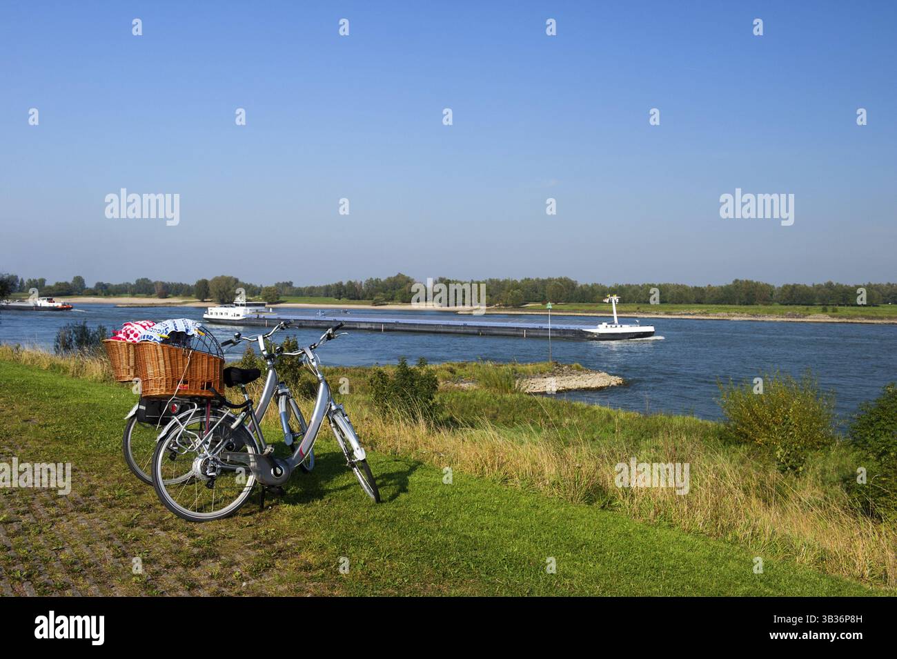 Big cargo boat on the Dutch river and parked bicycles Stock Photo - Alamy