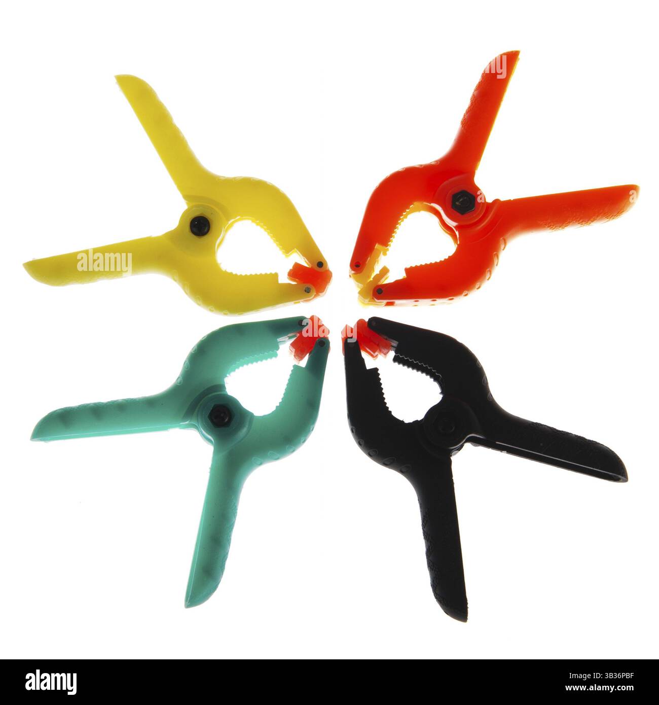 Four plastic clamps isolated over white background Stock Photo - Alamy