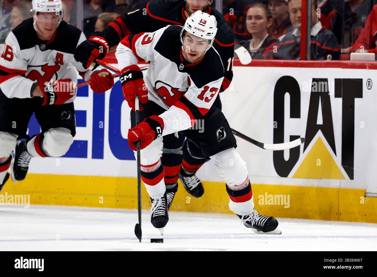 New Jersey Devils' Nico Hischier (13) gathers in the puck against the ...