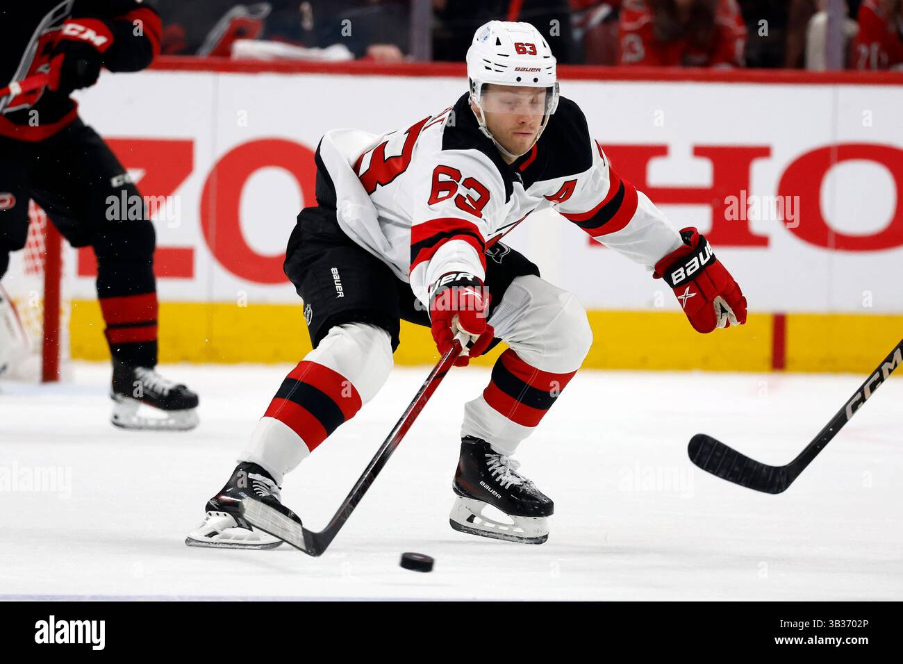 New Jersey Devils' Jesper Bratt (63) reaches for the puck against the ...