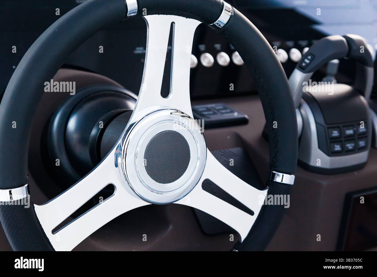 Motor yacht control panel. Steering wheel, gear levers, control buttons ...
