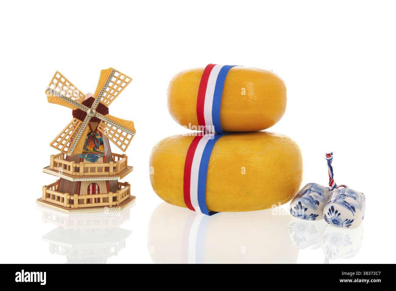 Two whole dutch cheeses with ribbon in flag colors isolated over white ...