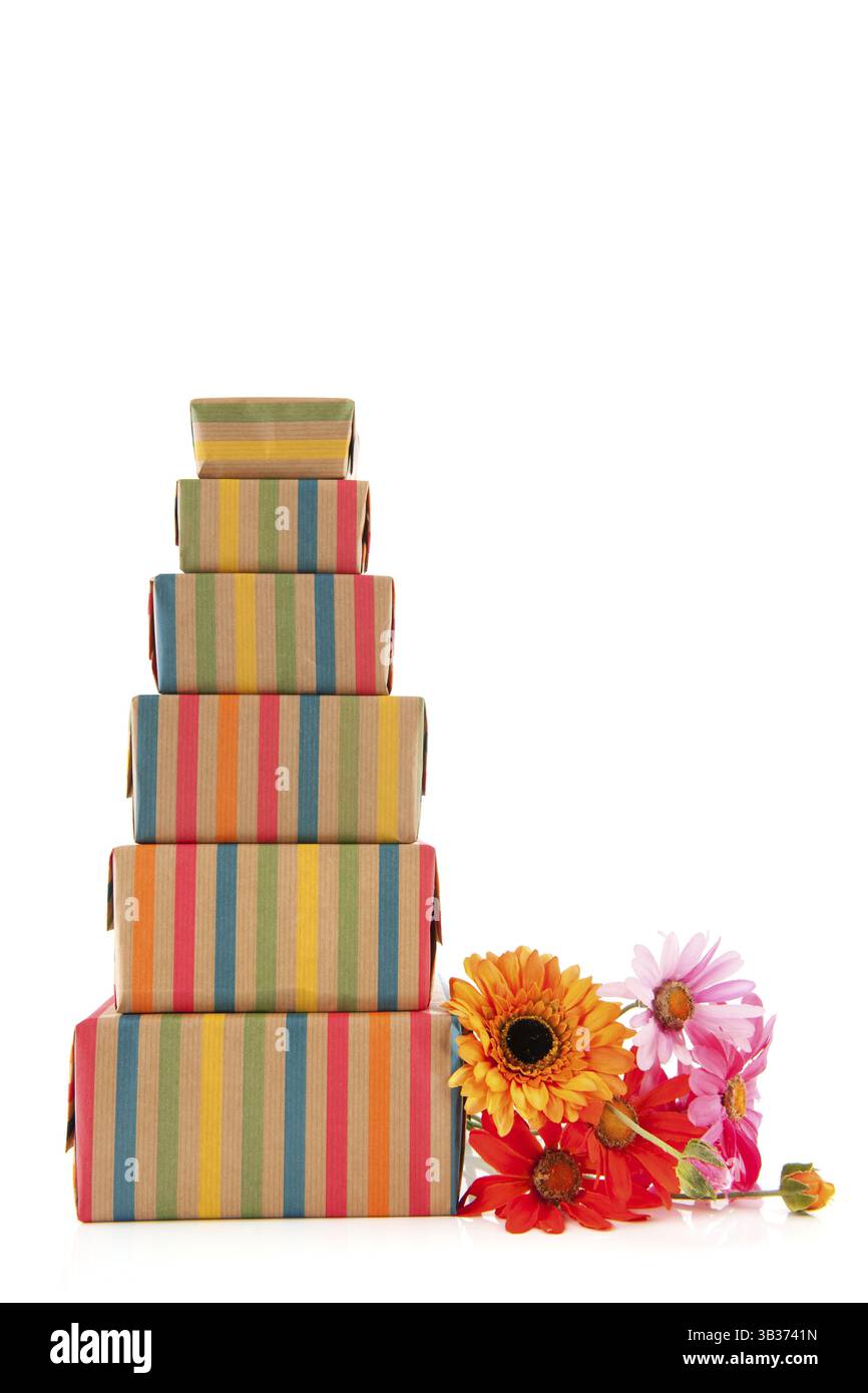 Colorful stack with wrapped presents and flowers isolated on white ...