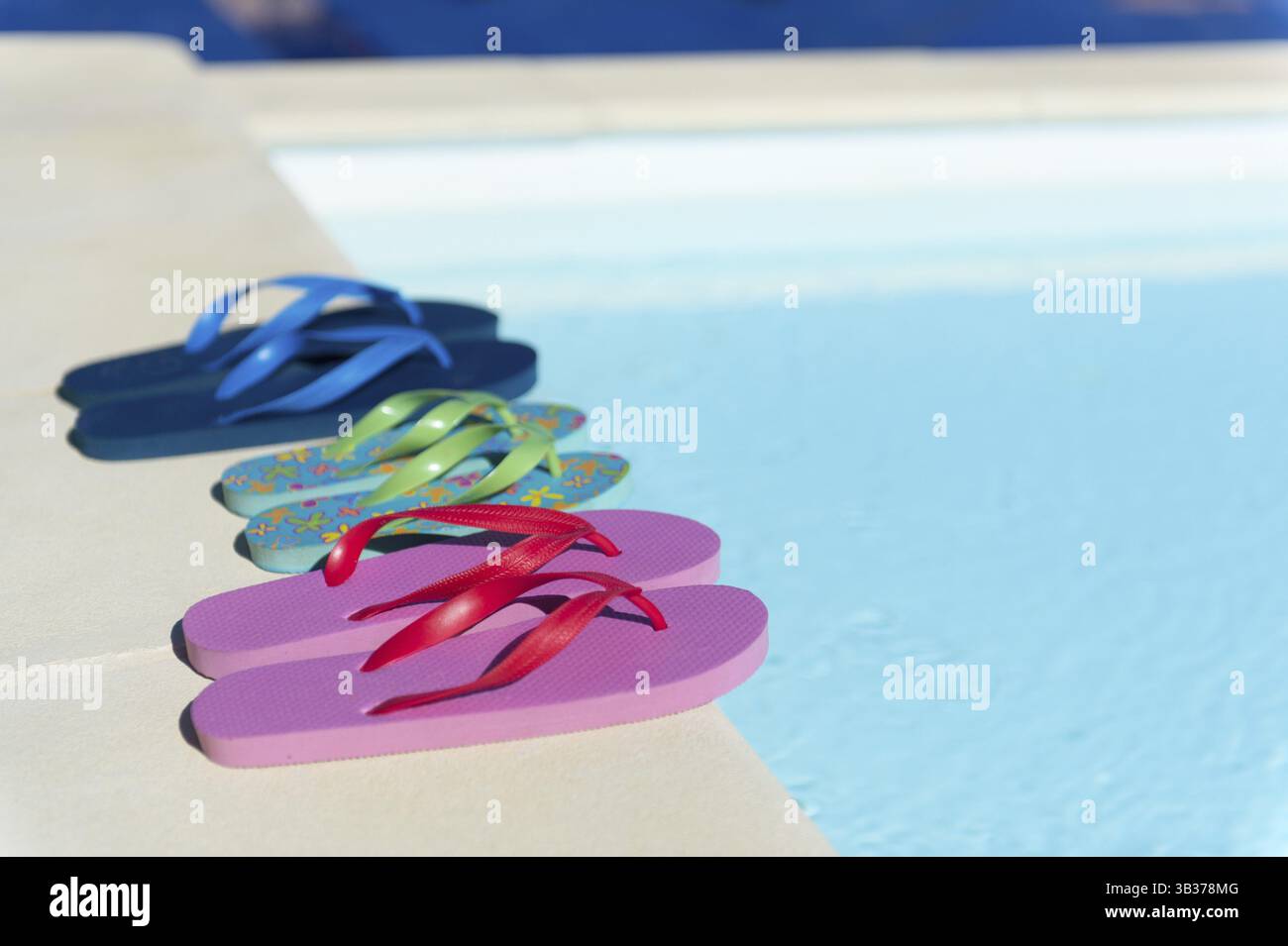 Flip flops from the whole family at the swimming pool Stock Photo - Alamy