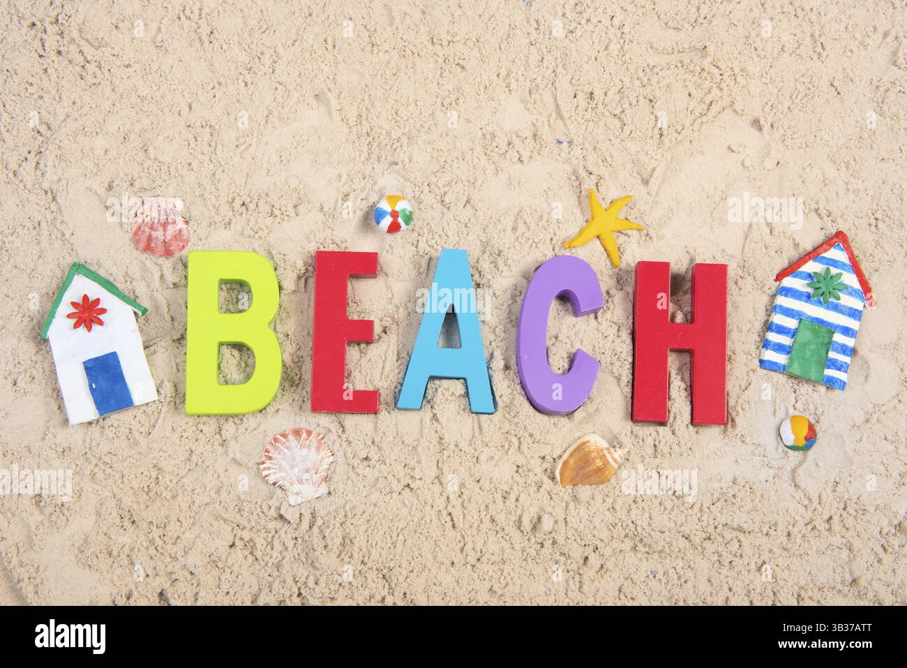 Hand made Miniature beach huts in sand Stock Photo - Alamy