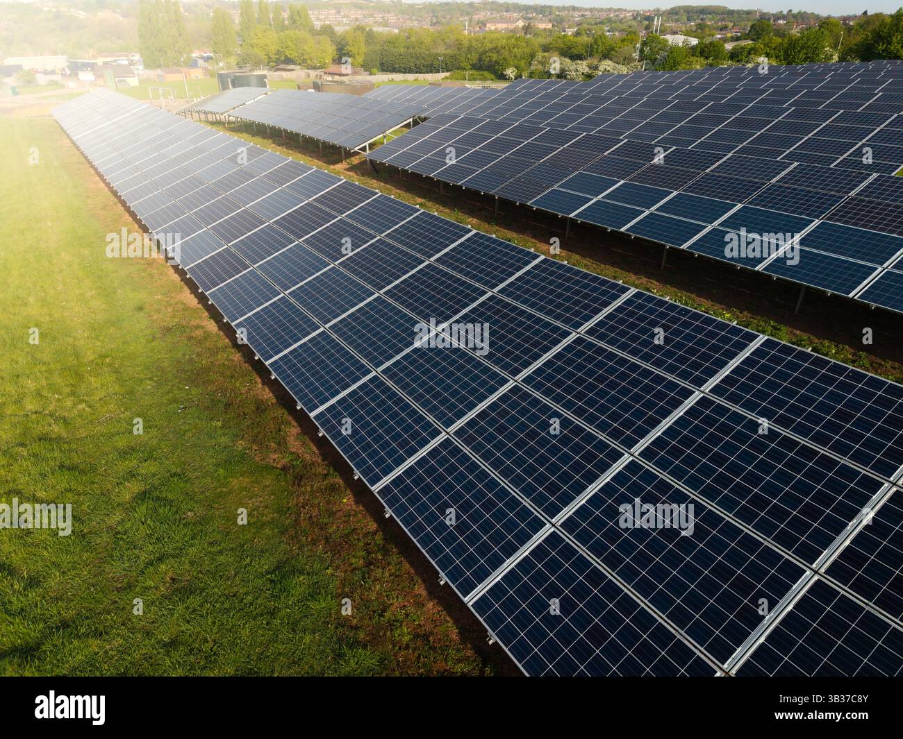 Rows of photovoltaic solar panels on agricultural land generating clean ...