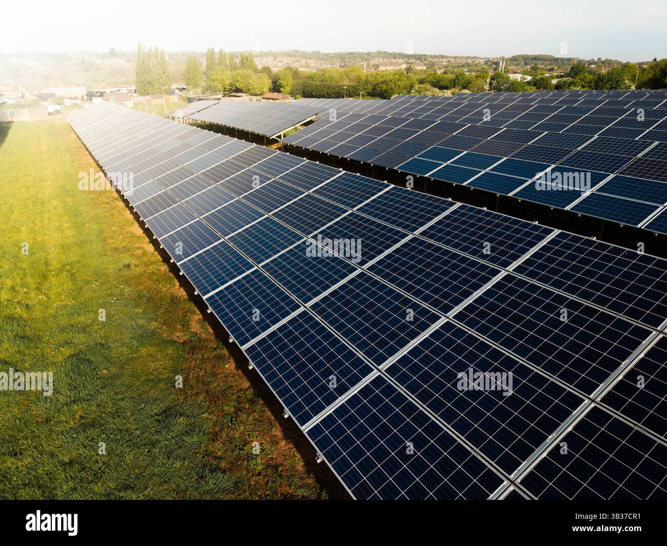 Rows of photovoltaic solar panels on agricultural land generating clean ...