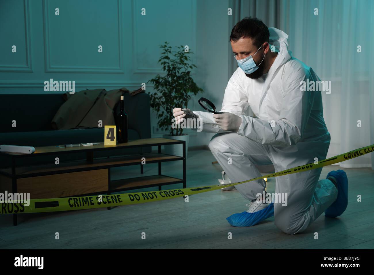 Forensic expert with tweezers examining hair through magnifying glass ...