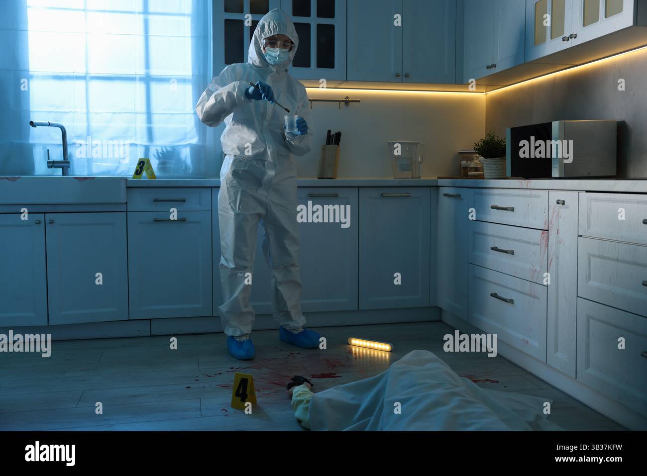 Forensic expert collecting bullet shell into container near dead body ...