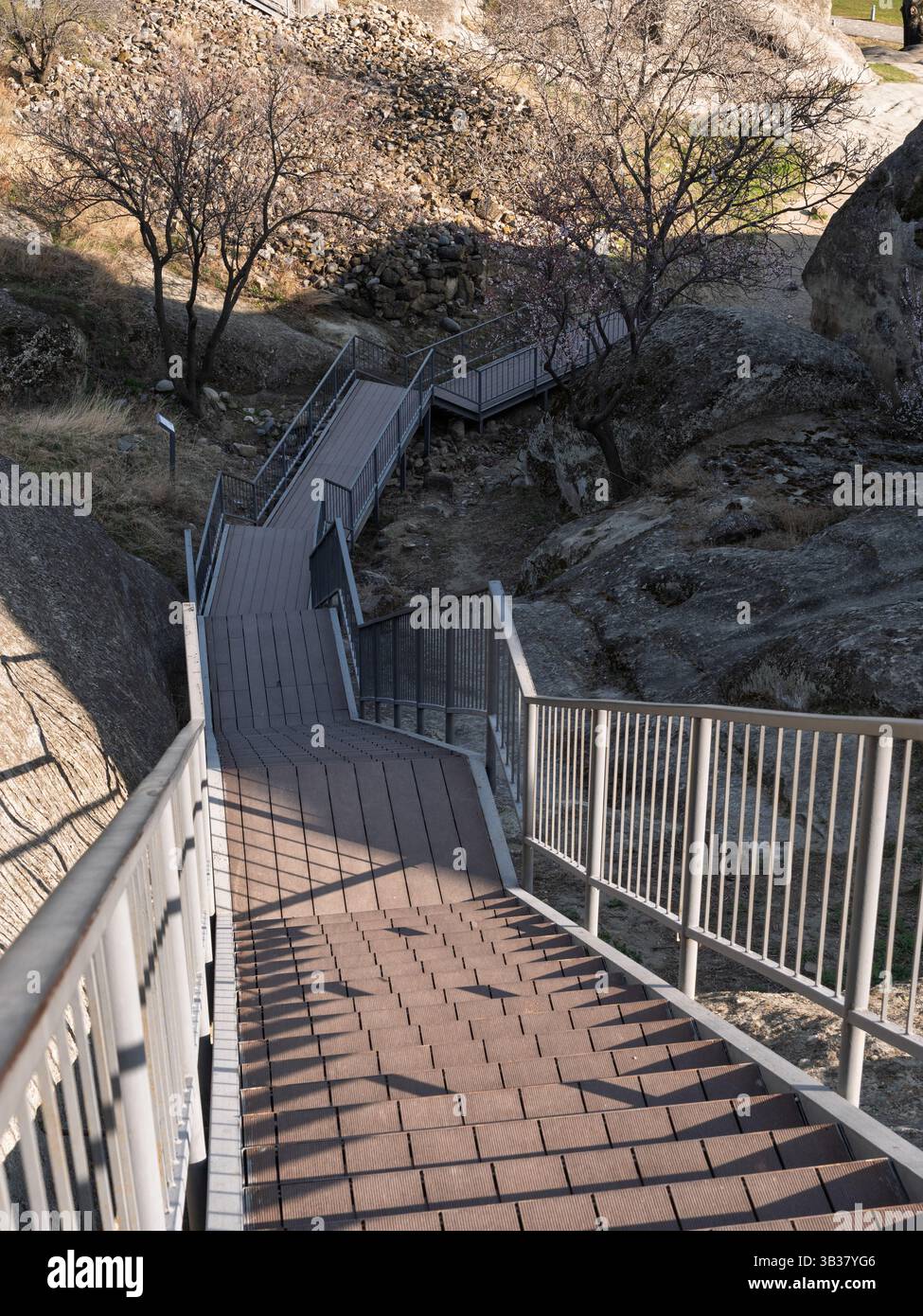 Wooden staircase and walkway leading through a rocky natural area Stock ...