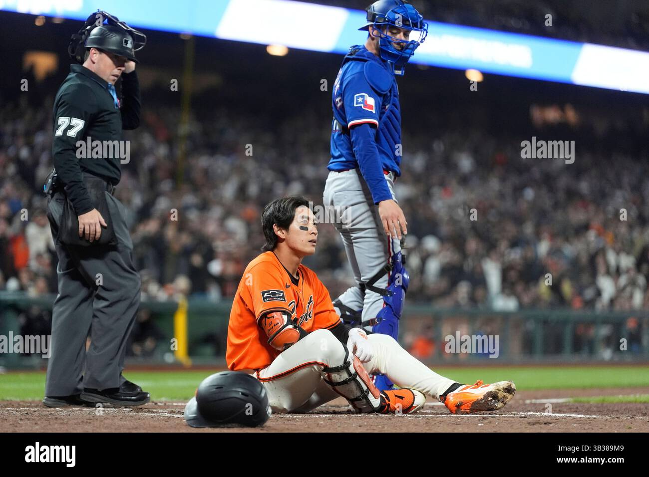 San Francisco Giants' Jung Hoo Lee, bottom reacts under Texas Rangers ...