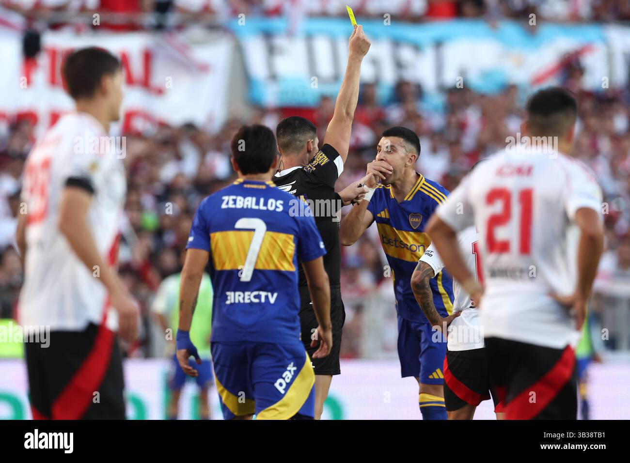 Argentine referee Nicolas Ramirez C shows a yellow card to Boca Juniors ...