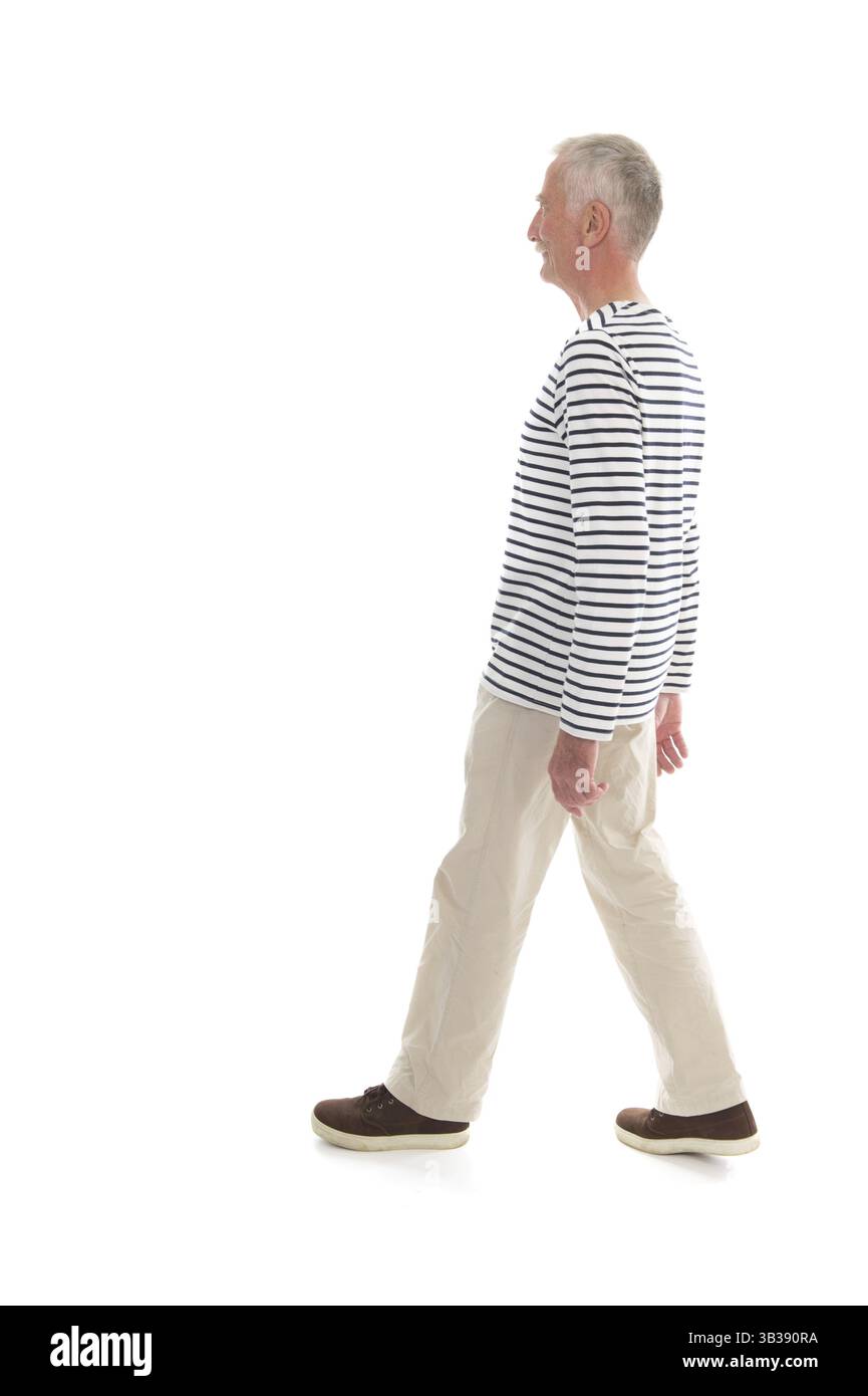 Senior man walking with full body in studio isolated over white ...