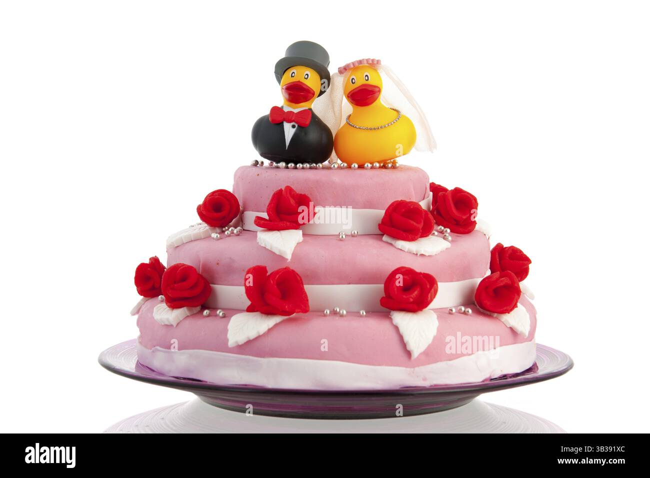 Pink wedding cake and funny couple ducks with red roses isolated over ...