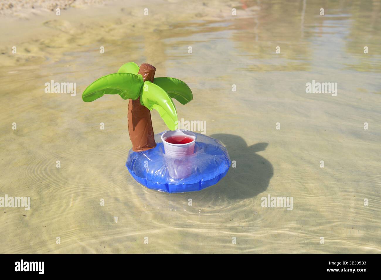 Inflatable Palm tree with cocktail drink Stock Photo - Alamy