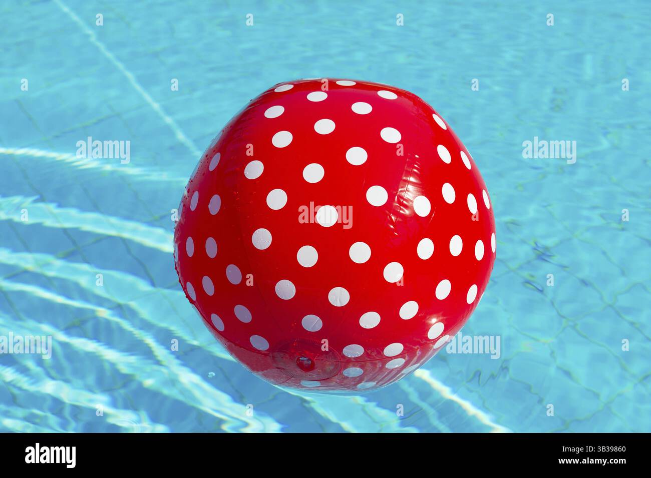 Beach ball floats in pool hi-res stock photography and images - Alamy