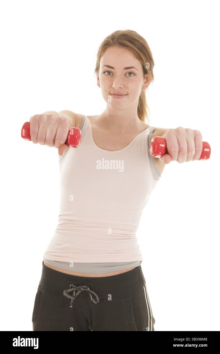 Slim young woman exercising with small dumbbells isolated over white ...