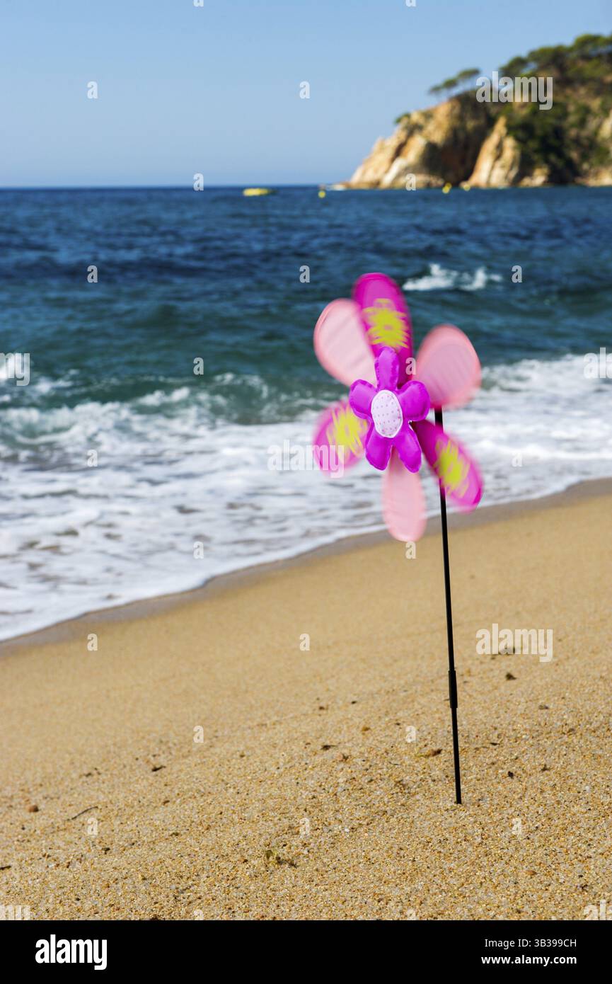 Turning colorful wind mill at the summer beach Stock Photo - Alamy