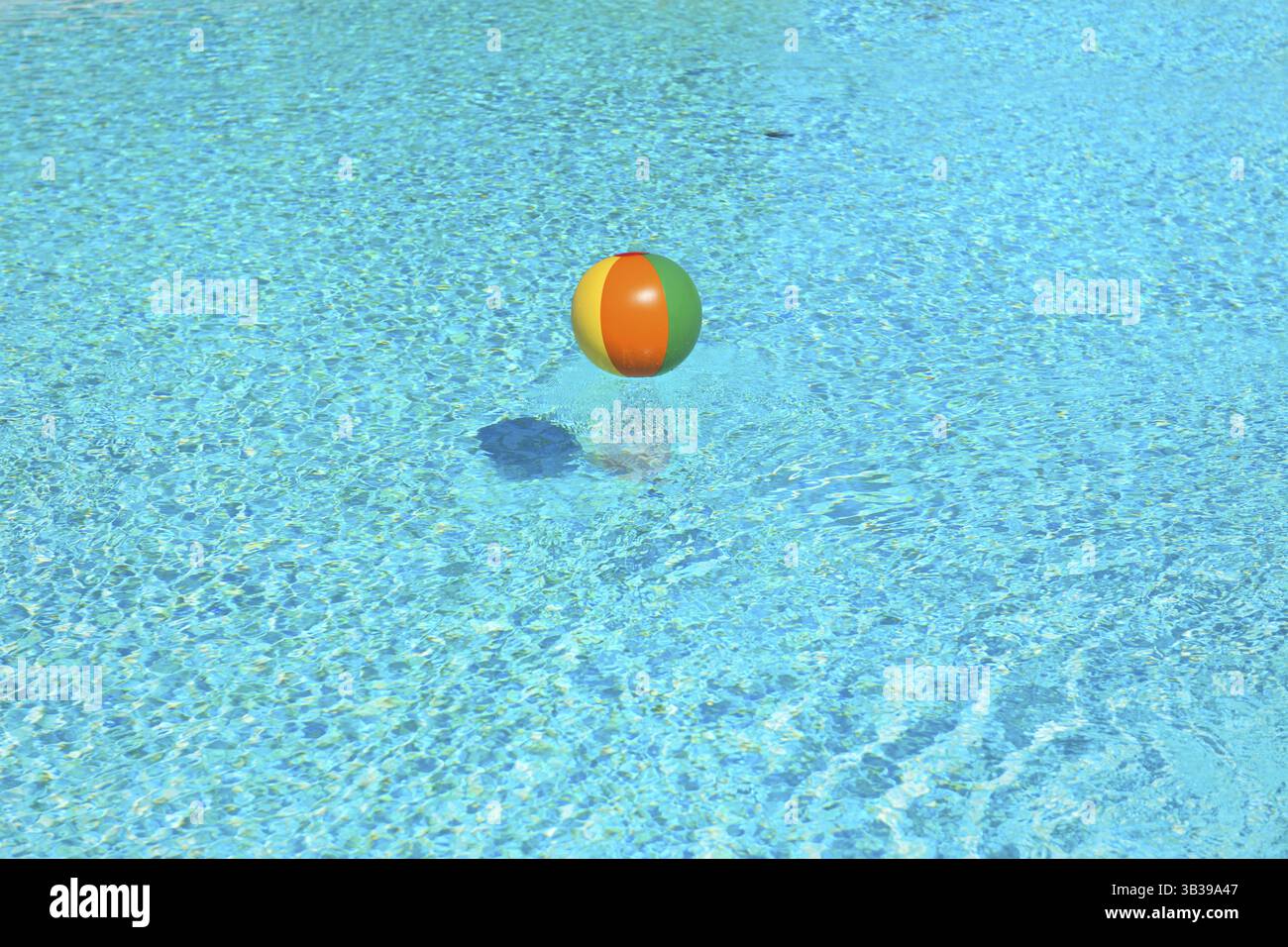 Inflatable colorful beach ball floating in water Stock Photo - Alamy