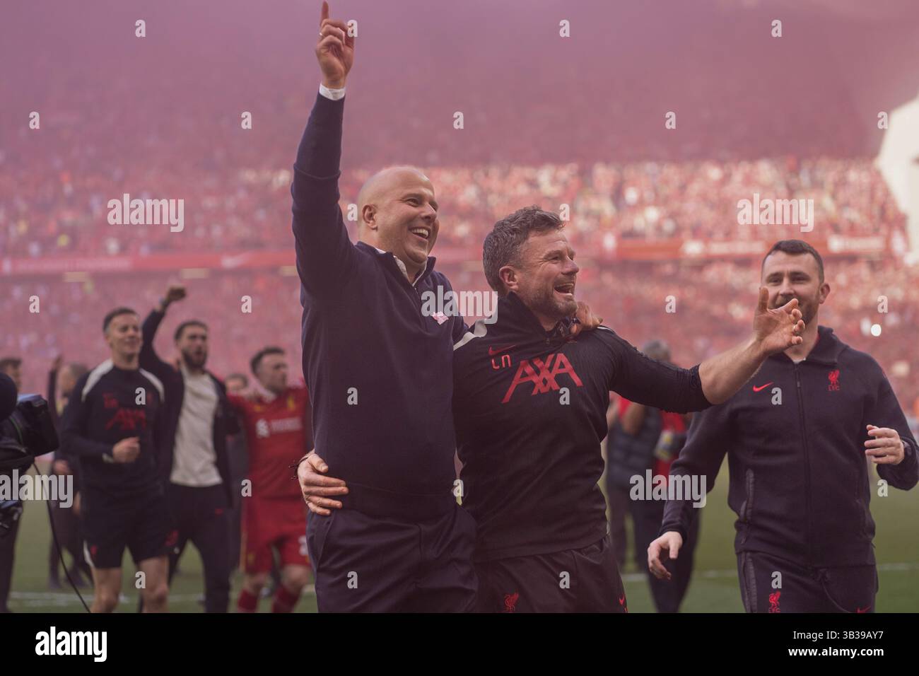 Liverpool manager Arne Slot celebrates with Lee Nobes the club's Head ...
