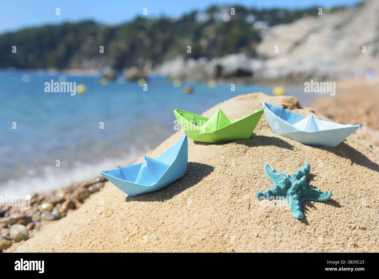 Paper boats in the sand at the beach Stock Photo - Alamy