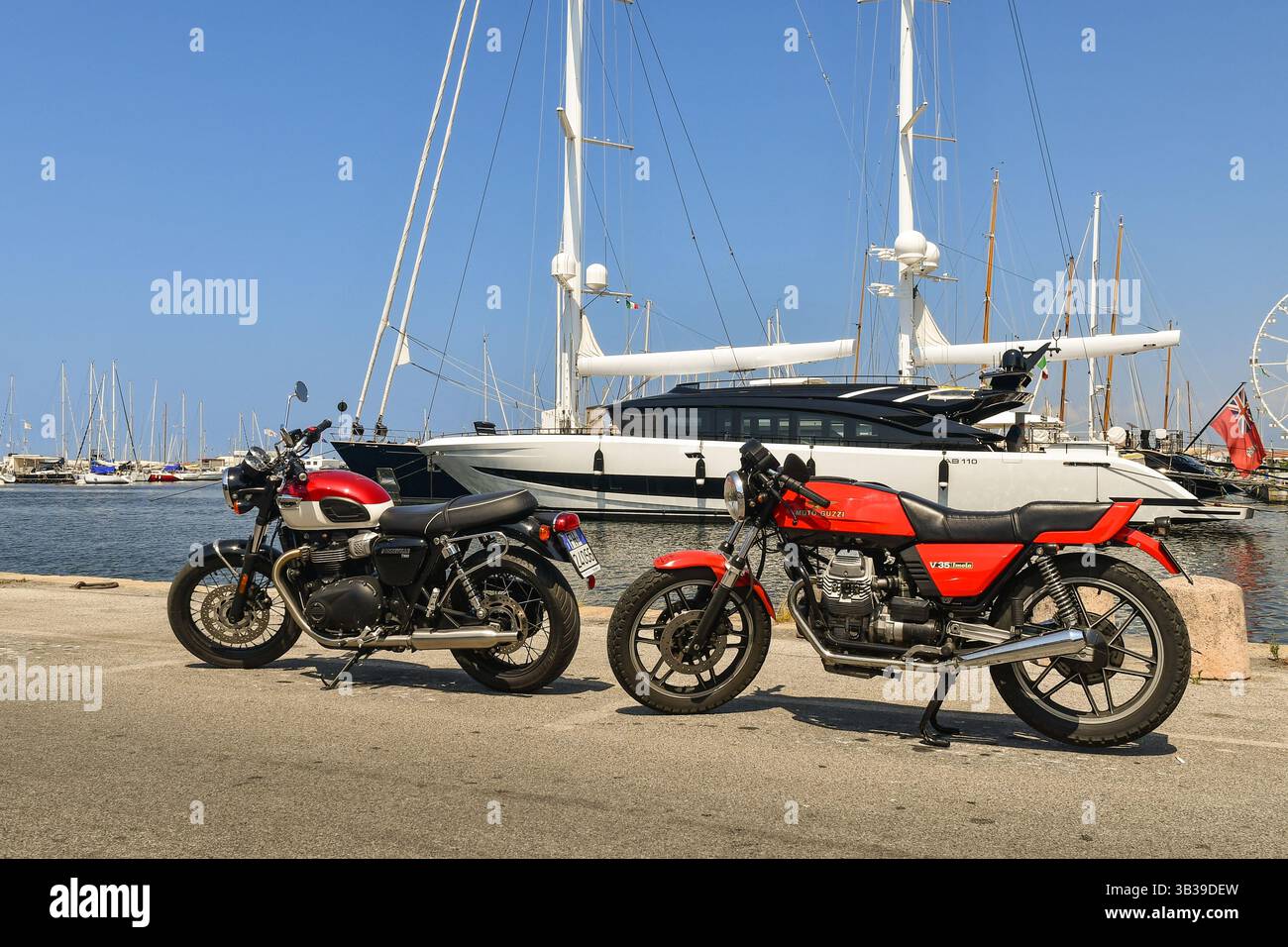 A Triumph Bonneville T100 and a Moto Guzzi V35 Imola motorbikes parked ...