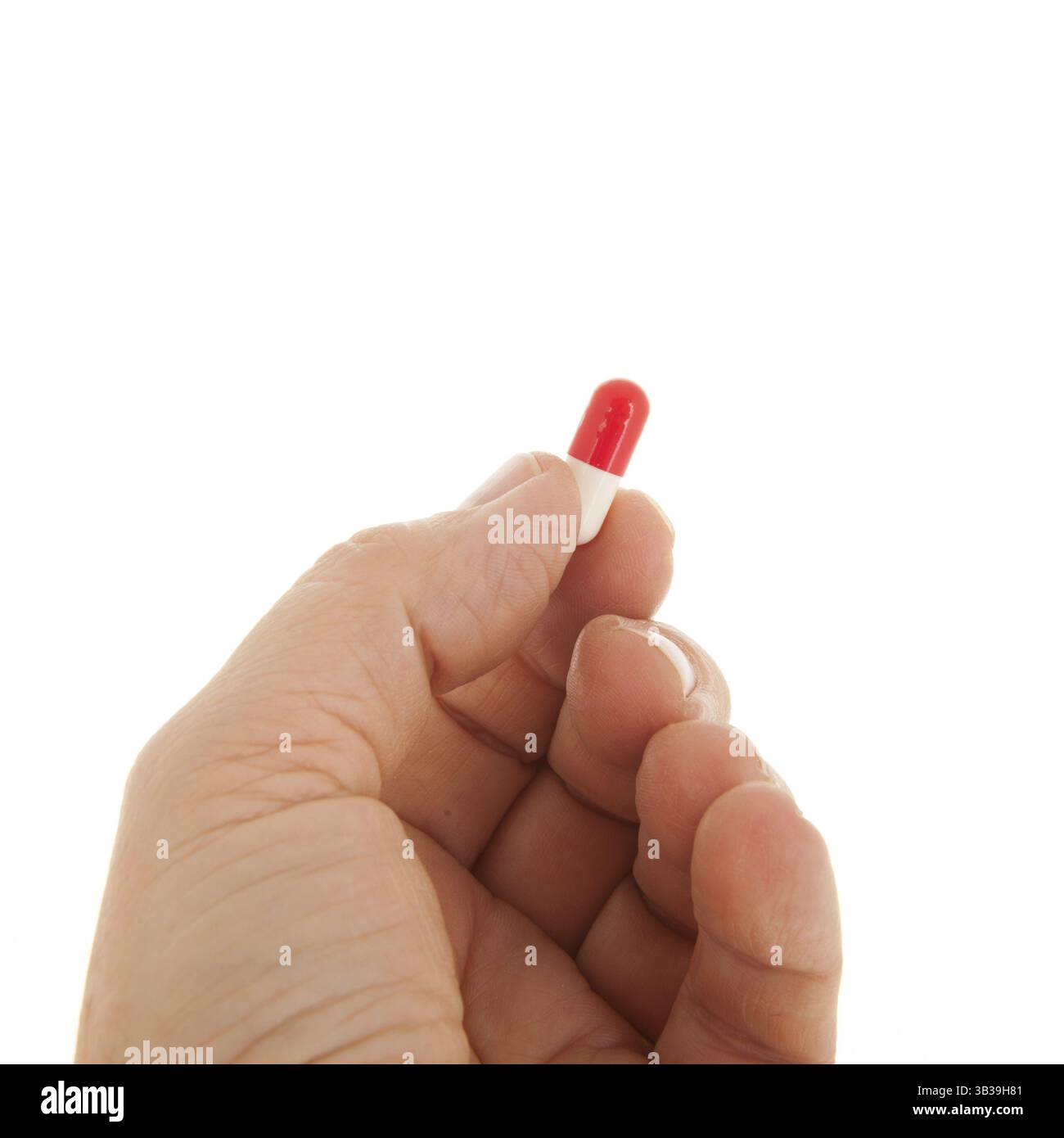 Old hand with capsule pill in red and white Stock Photo - Alamy