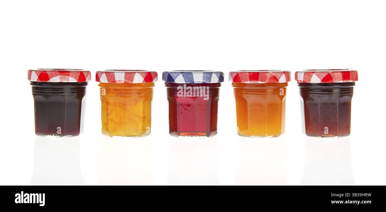 Five various pots of jam on white background Stock Photo - Alamy