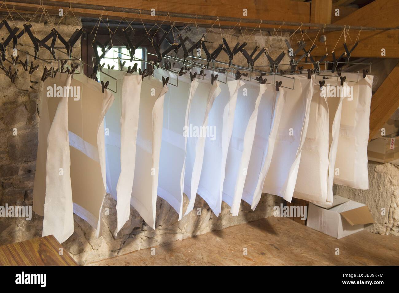 Hanging paper in mill interior Stock Photo - Alamy