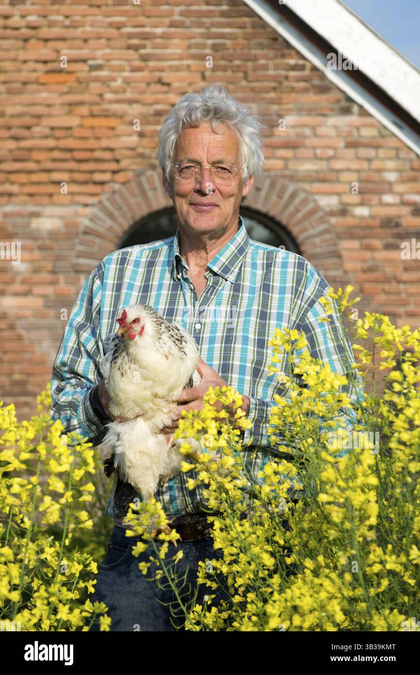 Farmer outdoor is carrying chickens Stock Photo - Alamy