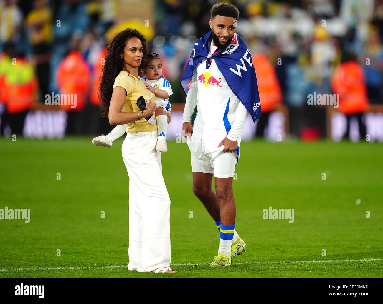 Leeds United's Jayden Bogle, his partner and child celebrate promotion ...