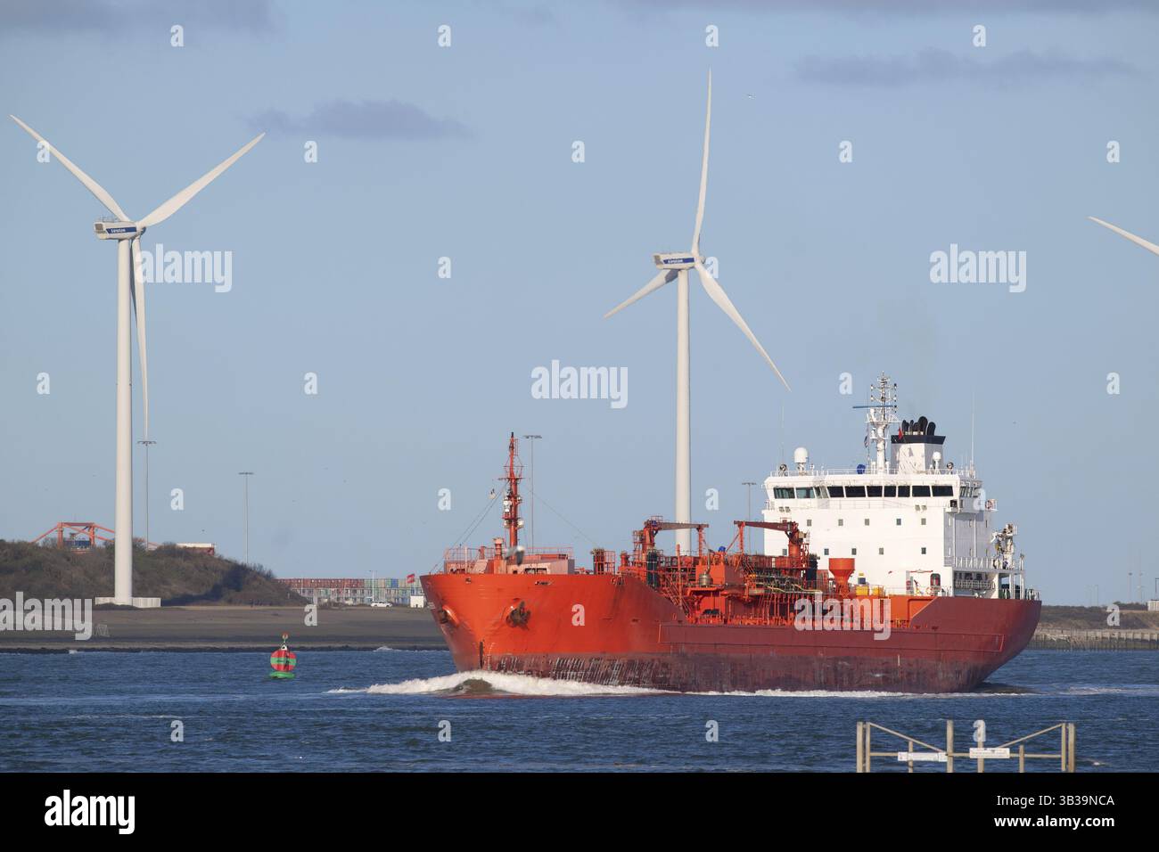 Red oil tanker in harbor with wind mills Stock Photo - Alamy