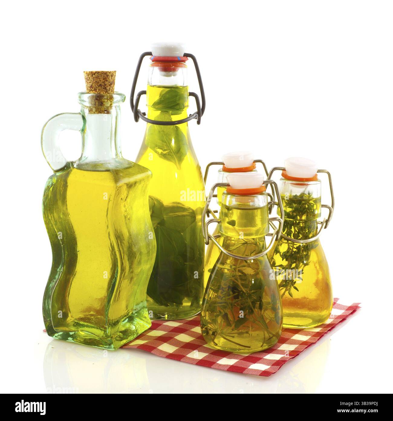 Olive oil with various kinds of herbs isolated over white Stock Photo ...
