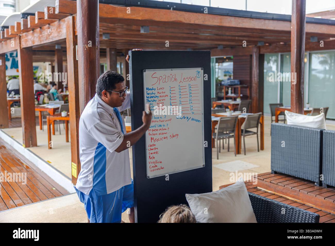 Spanish lesson at outdoor restaurant terrace with teacher explaining ...