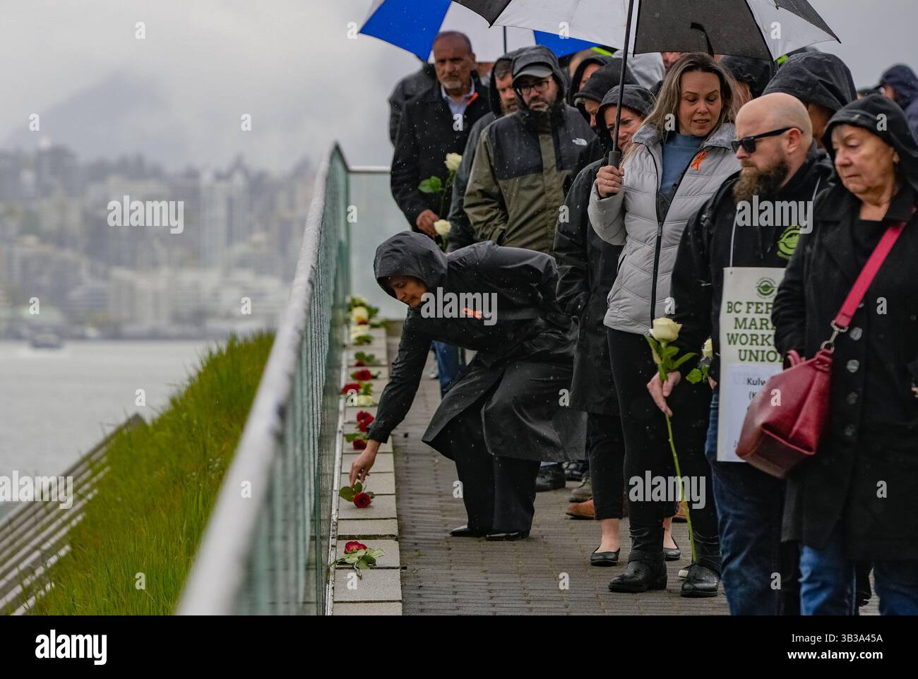 Vancouver, Canada. 28th Apr, 2025. A woman places a rose in front of a ...