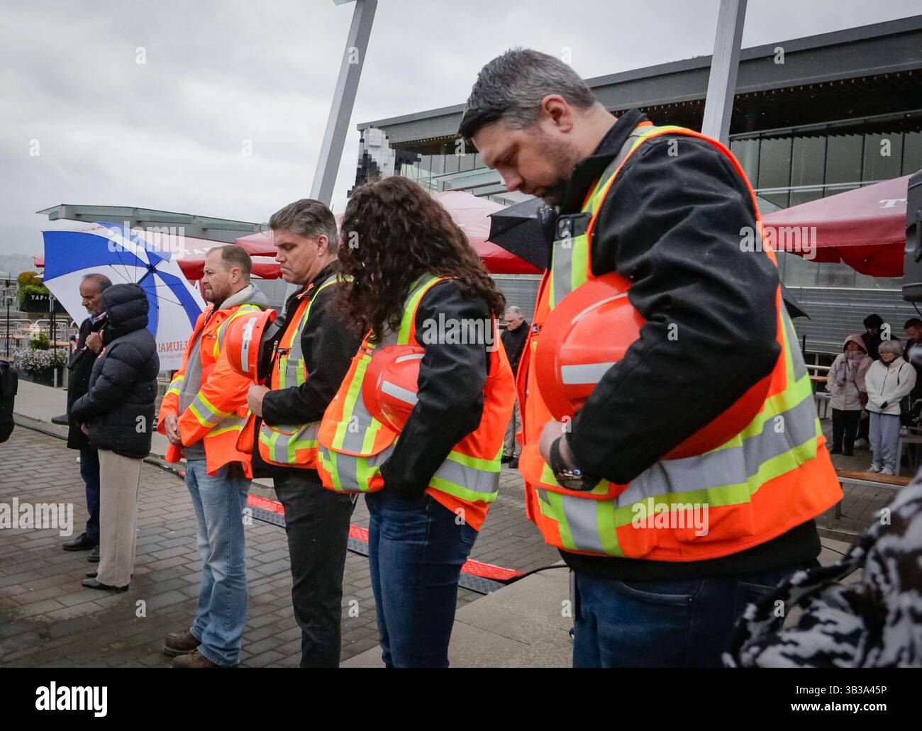Vancouver, Canada. 28th Apr, 2025. People observe a moment of silence ...